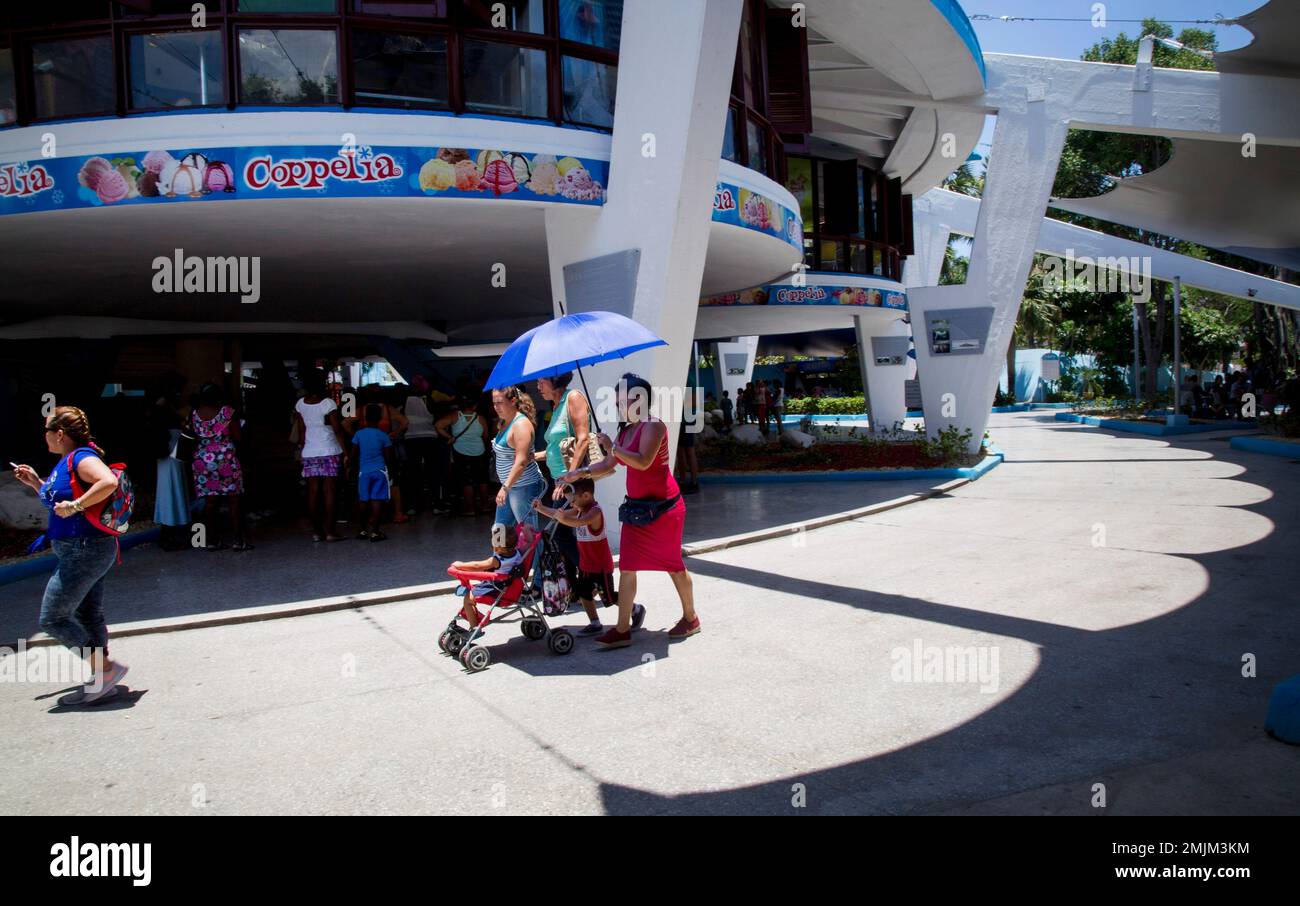People enjoy ice cream at the Coppelia ice cream shop in Havana, Cuba ...