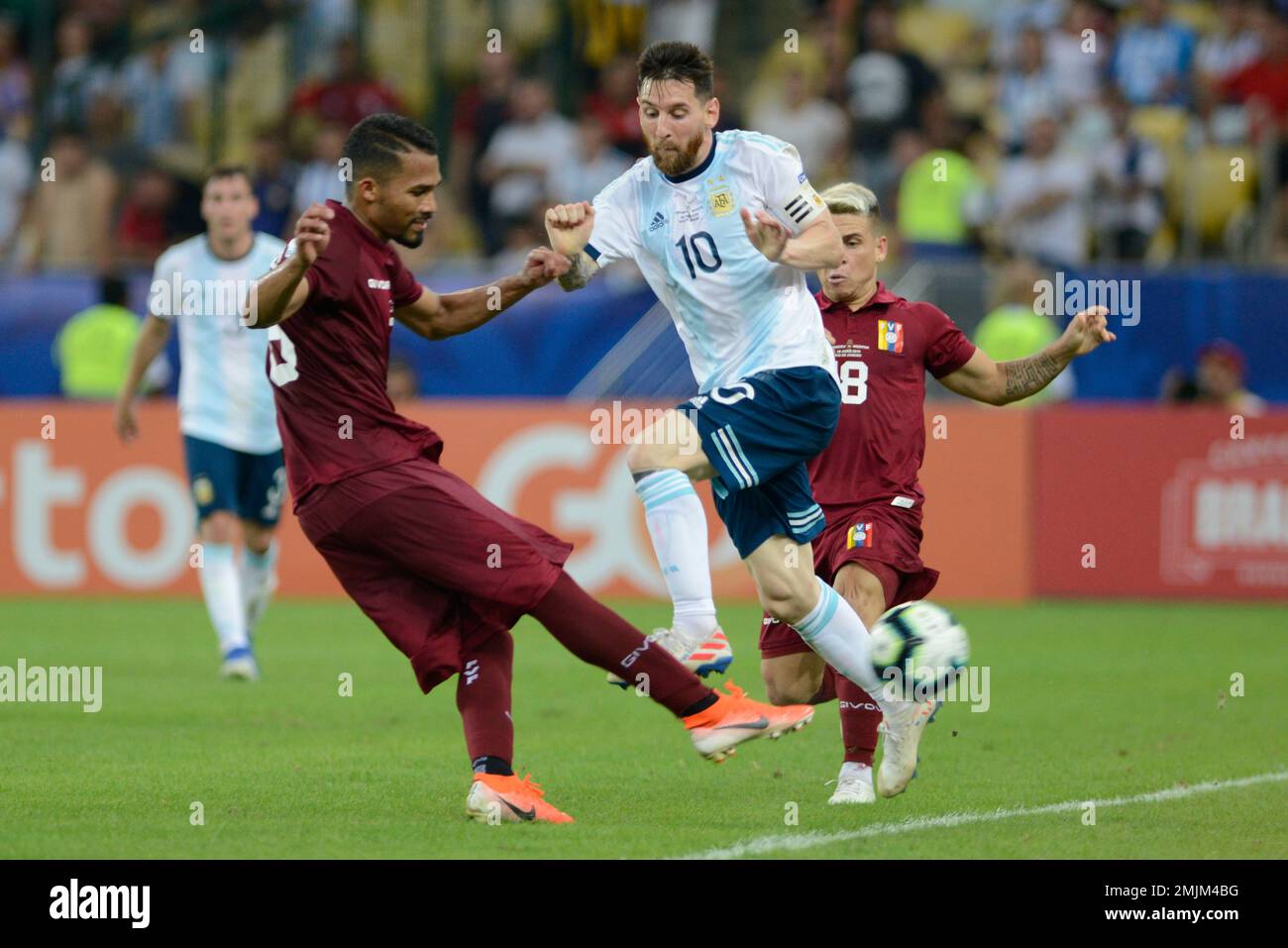 Argentina's Lionel Messi, center, and Venezuela's Yangel Herrera fight ...