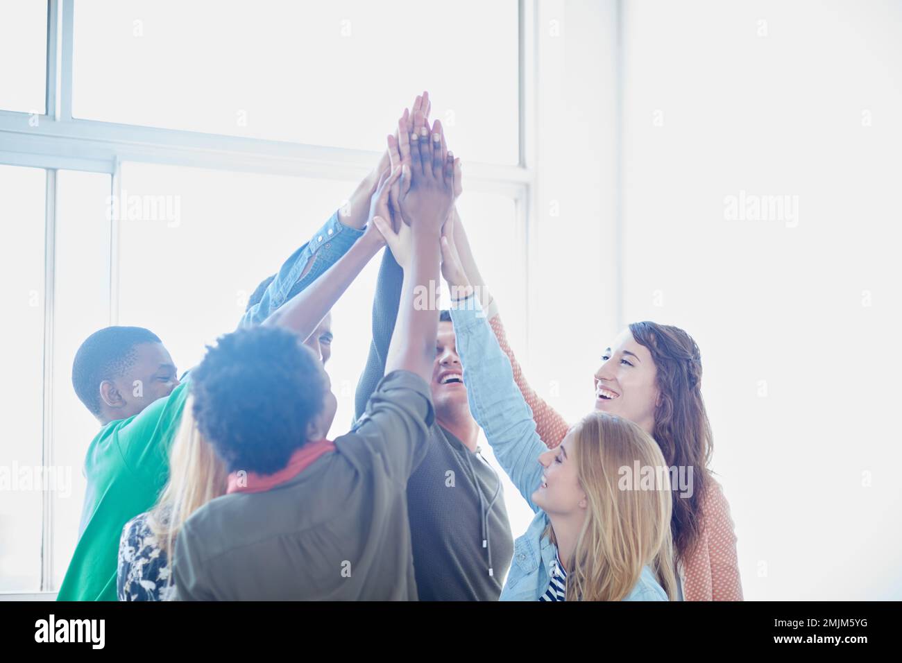 We did it. a group of university students high fiving one another ...