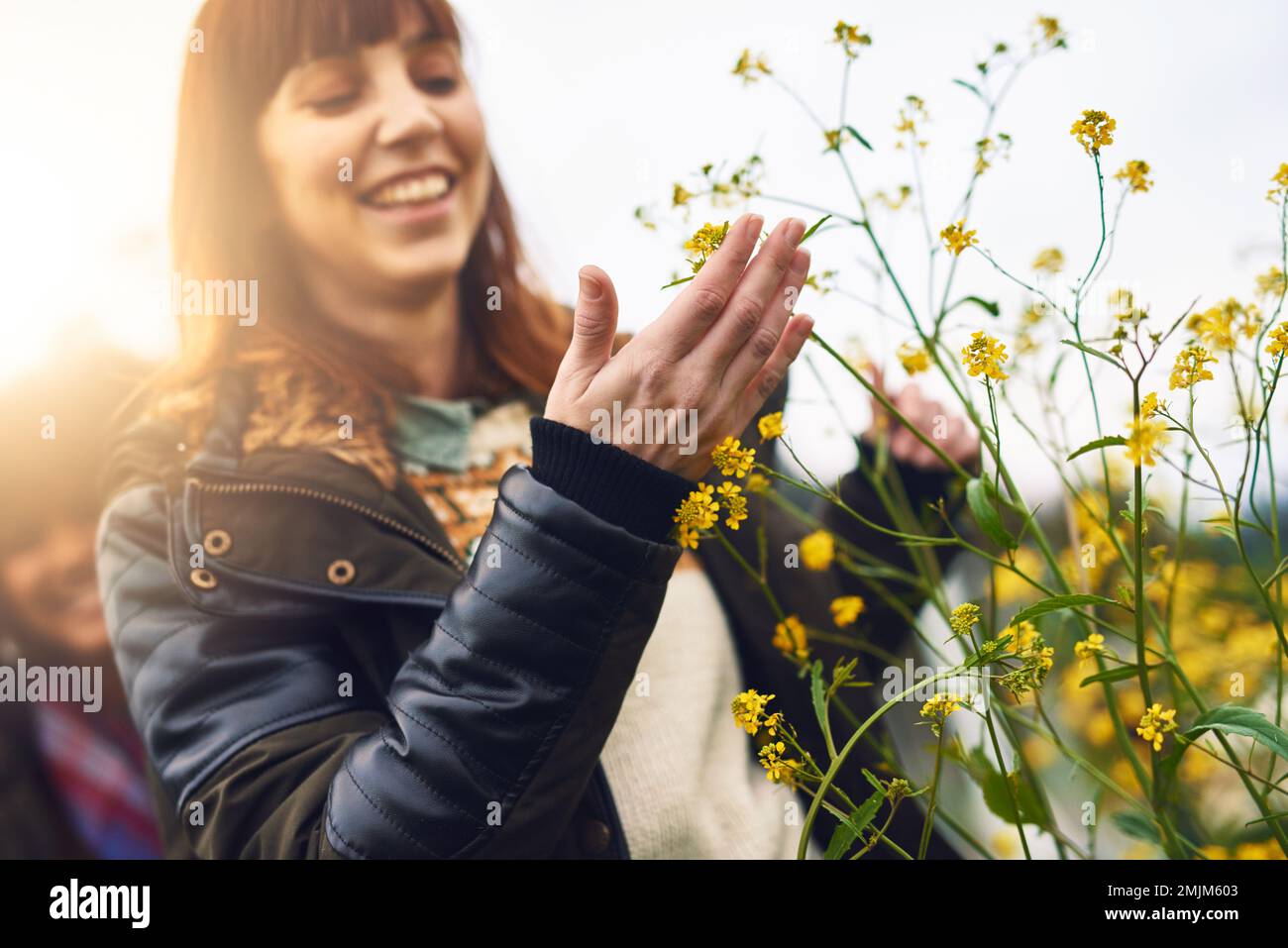 Discovering her inner flower child. two happy young woman standing in a ...