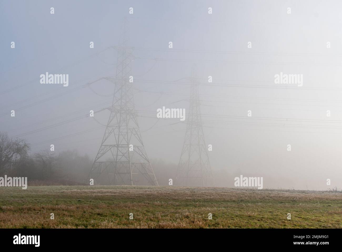 Pylons in the Mist Stock Photo - Alamy