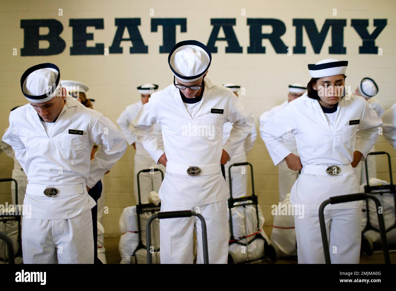Incoming plebes adjust their uniforms during Induction Day at the U.S ...