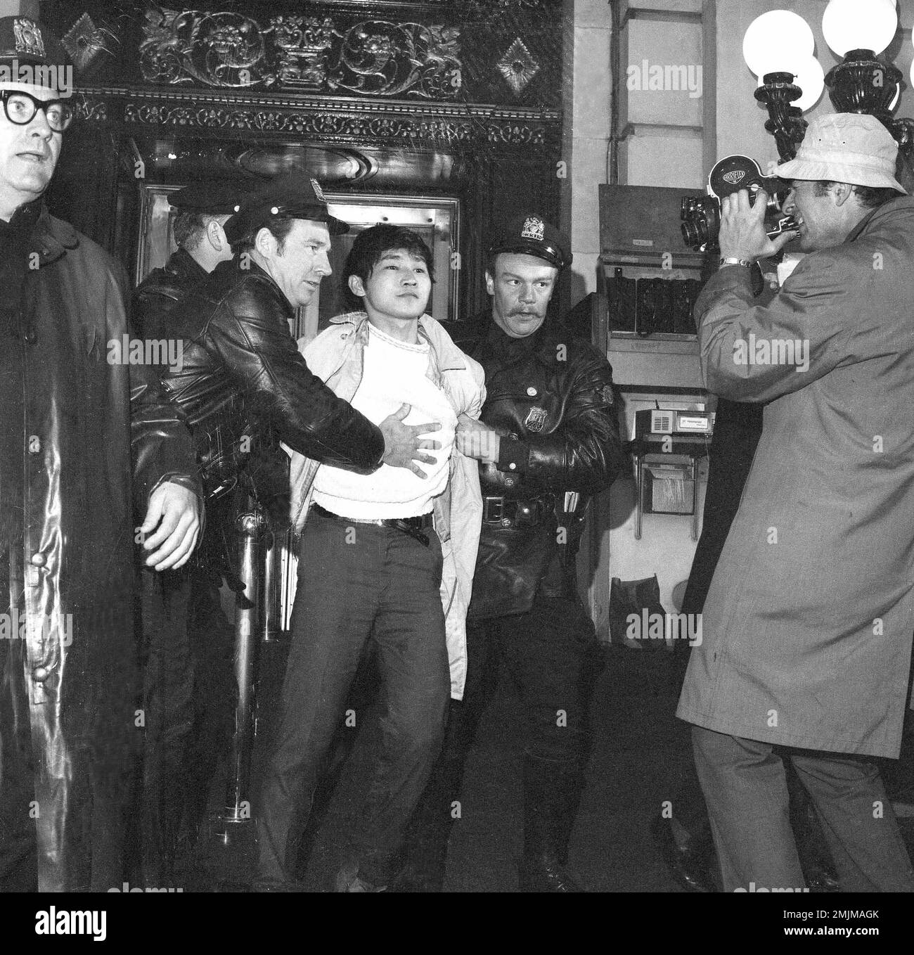 Police hold on tight to a man following a shot fired at Nationalist ...