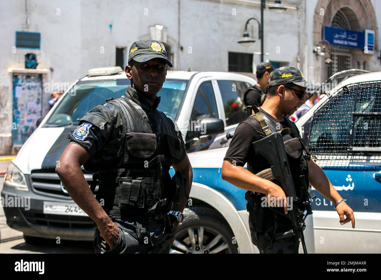 Tunisian police officers stand guard after an explosion in Tunis ...