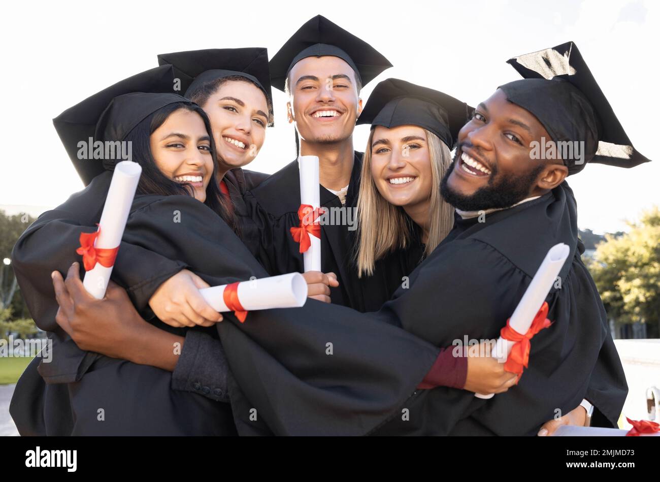 Graduation, group portrait and hug for celebration, success and ...