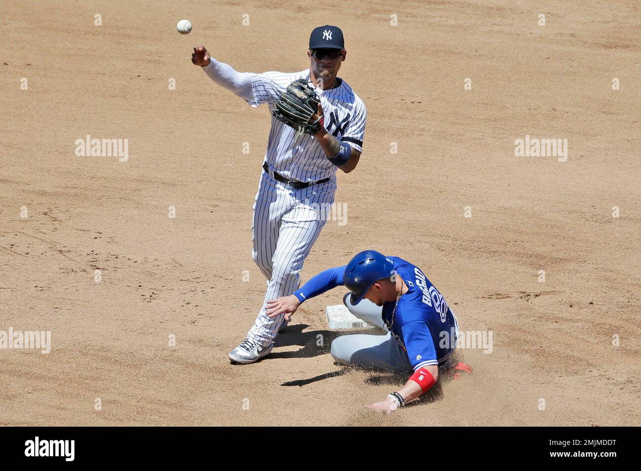 New York Yankees second baseman Gleyber Torres, left, turns a double ...