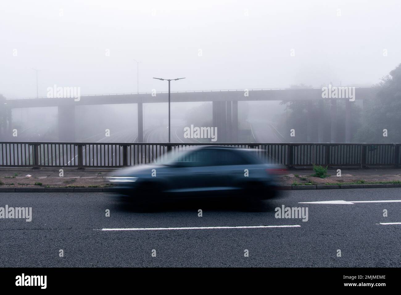 Car speeding past on a motorway roundabout Stock Photo - Alamy