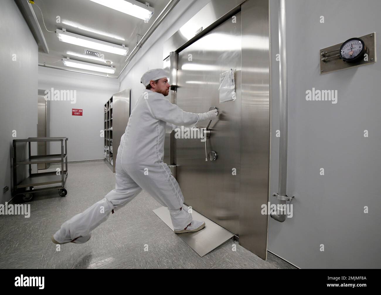 Jeremy Kent, Apollo sample curation processor, tugs to open the 1978 U ...