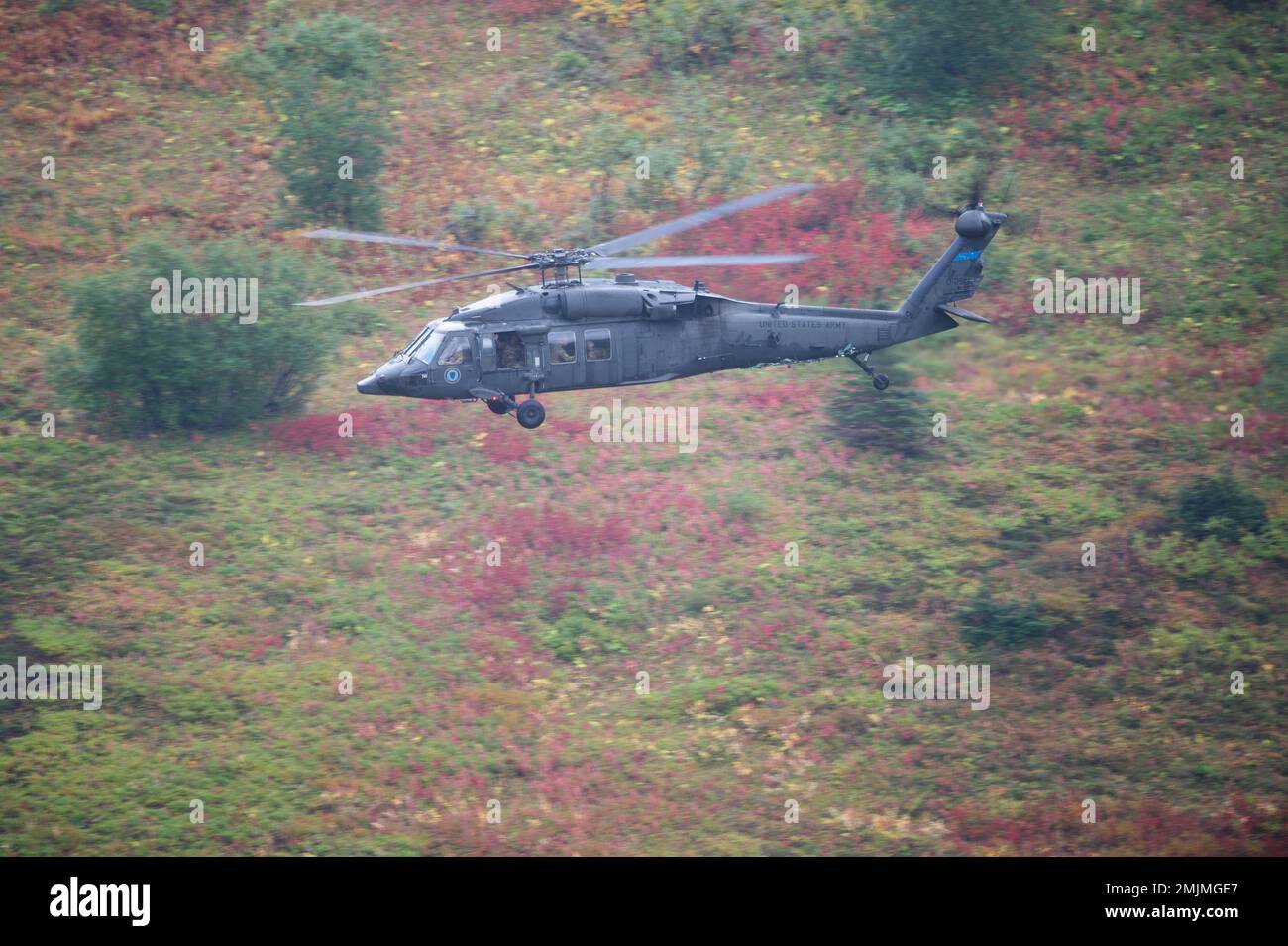 An Alaska Army National Guard UH-60L Black Hawk helicopter passes over ...