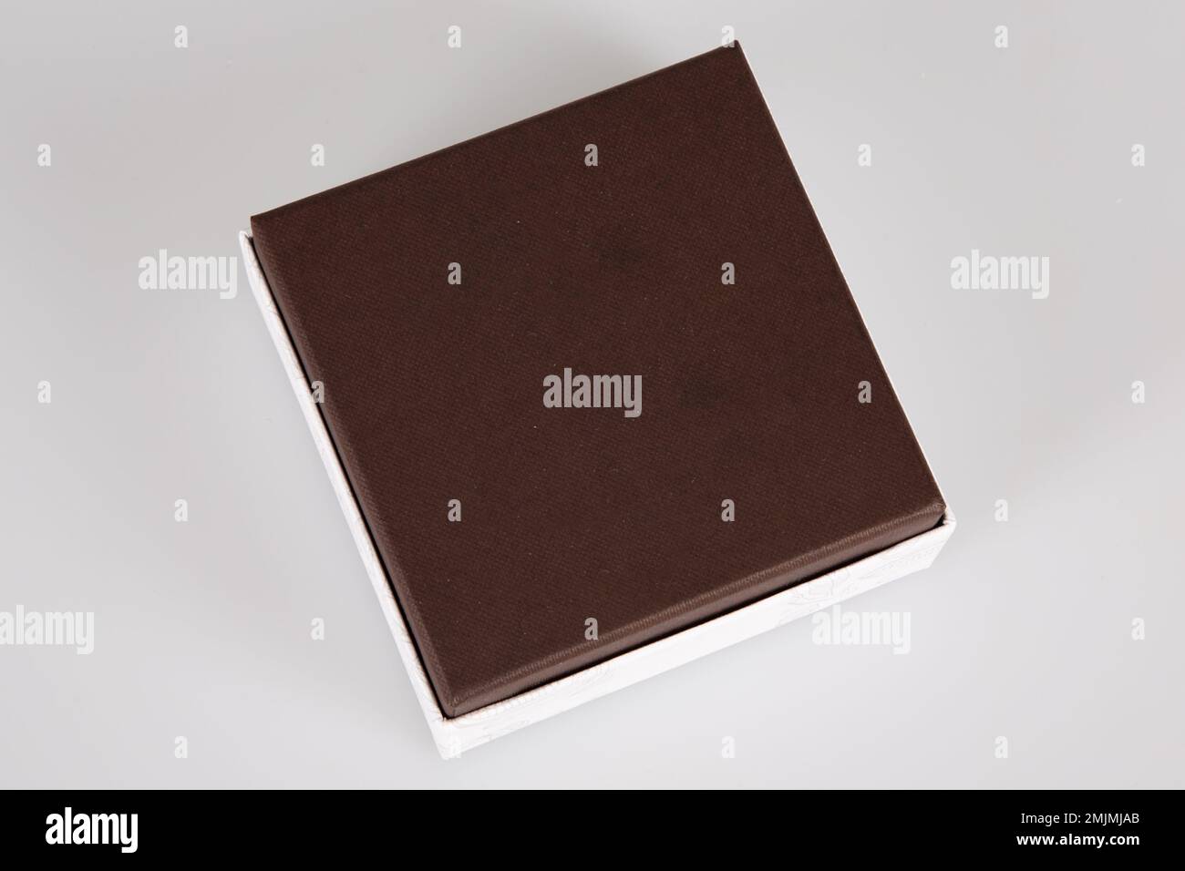 White small Gift Box with brown cower in grey background Stock Photo ...