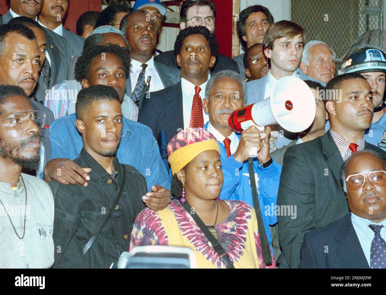New York City Mayor David Dinkins, with bullhorn, appeals to an angry ...