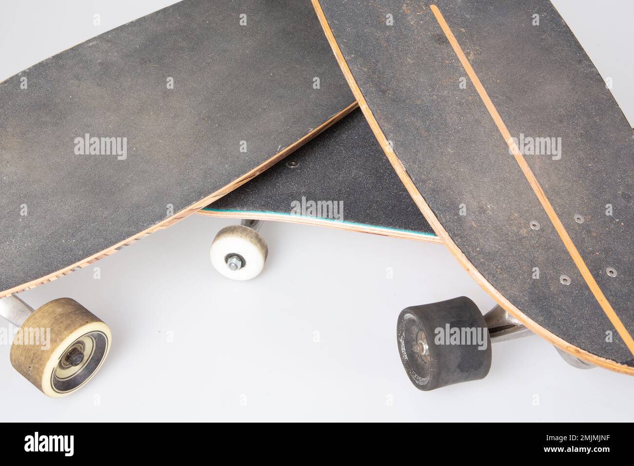 skateboard deck with trucks stacked on top of each other on white ...