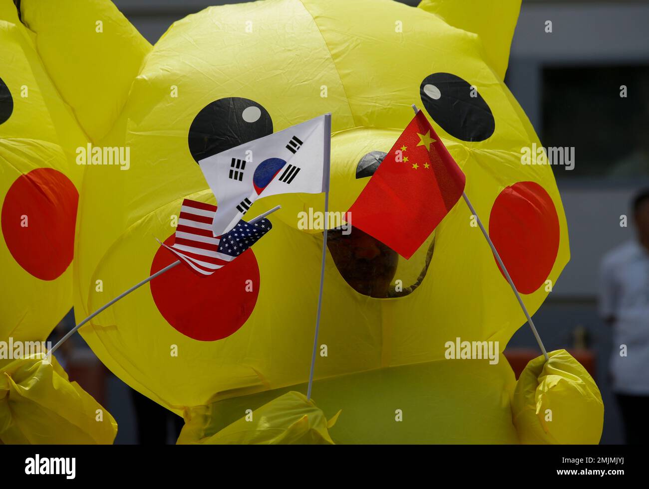 Environmental activists wearing Pikachu costumes hold flags of U.S ...