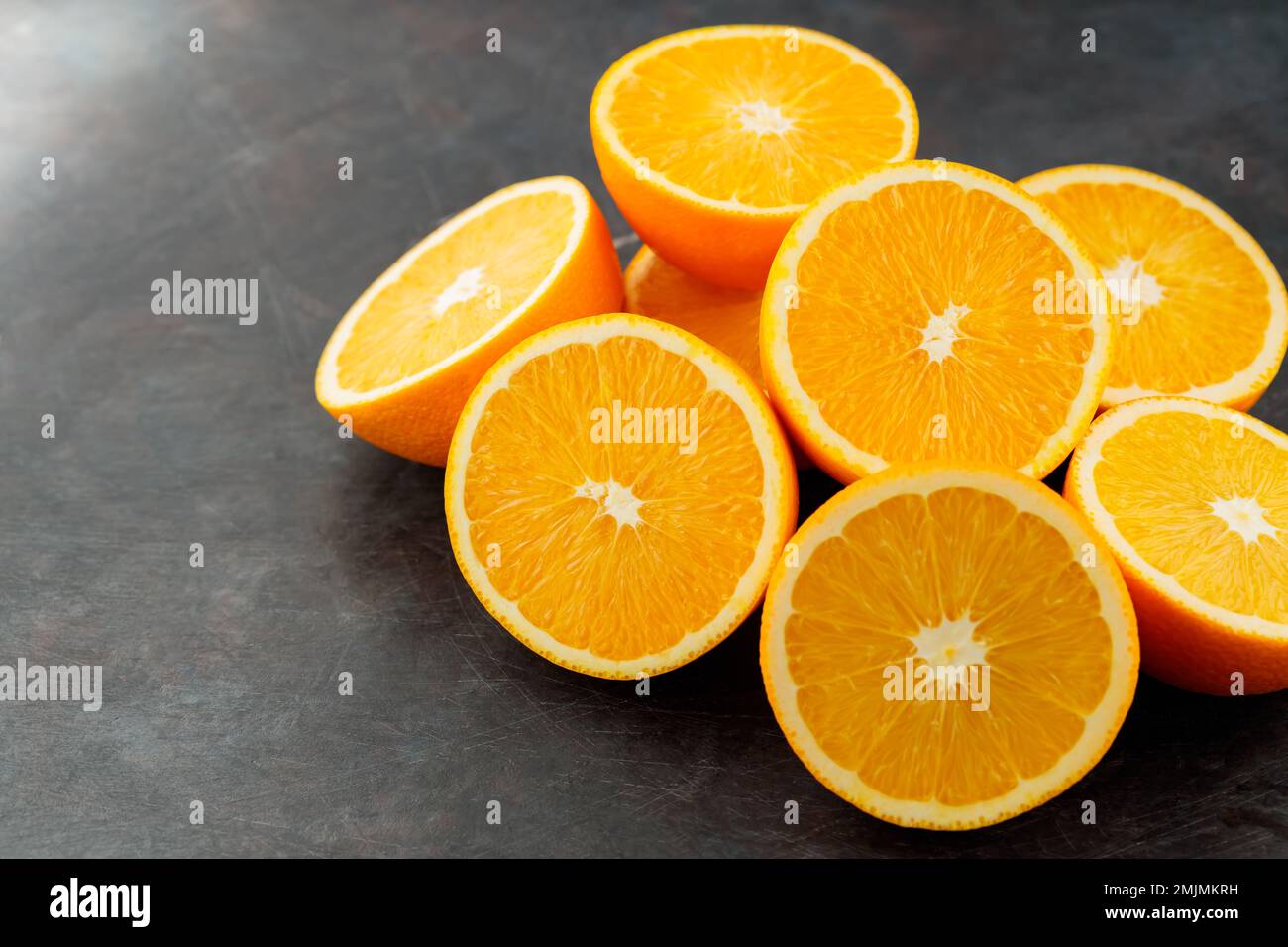 Orange slices on a black background. Halves of juicy oranges for a ...
