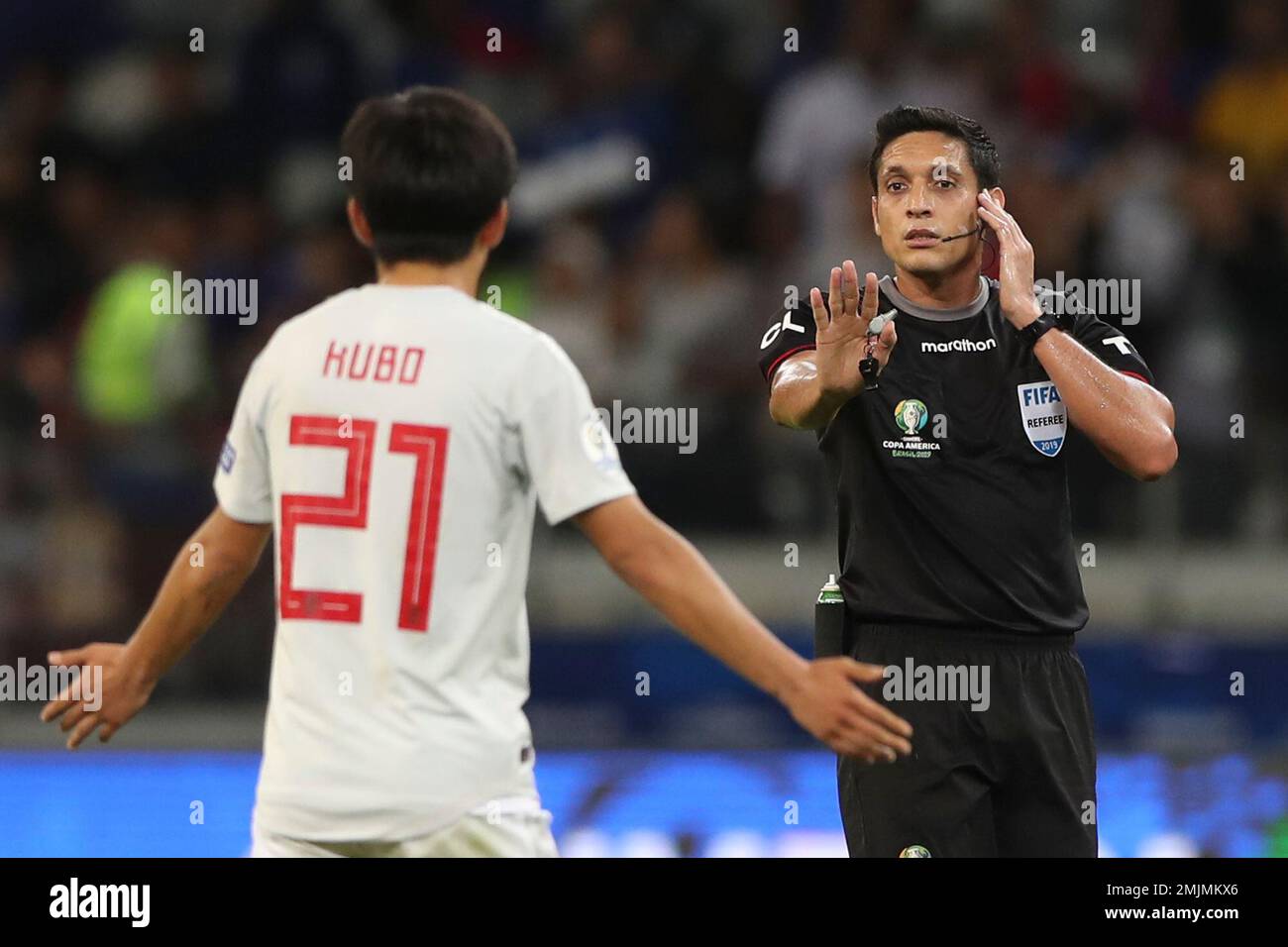 Referee Jesus Valenzuela, right, gestures to Japan's Takefusa Kubo ...
