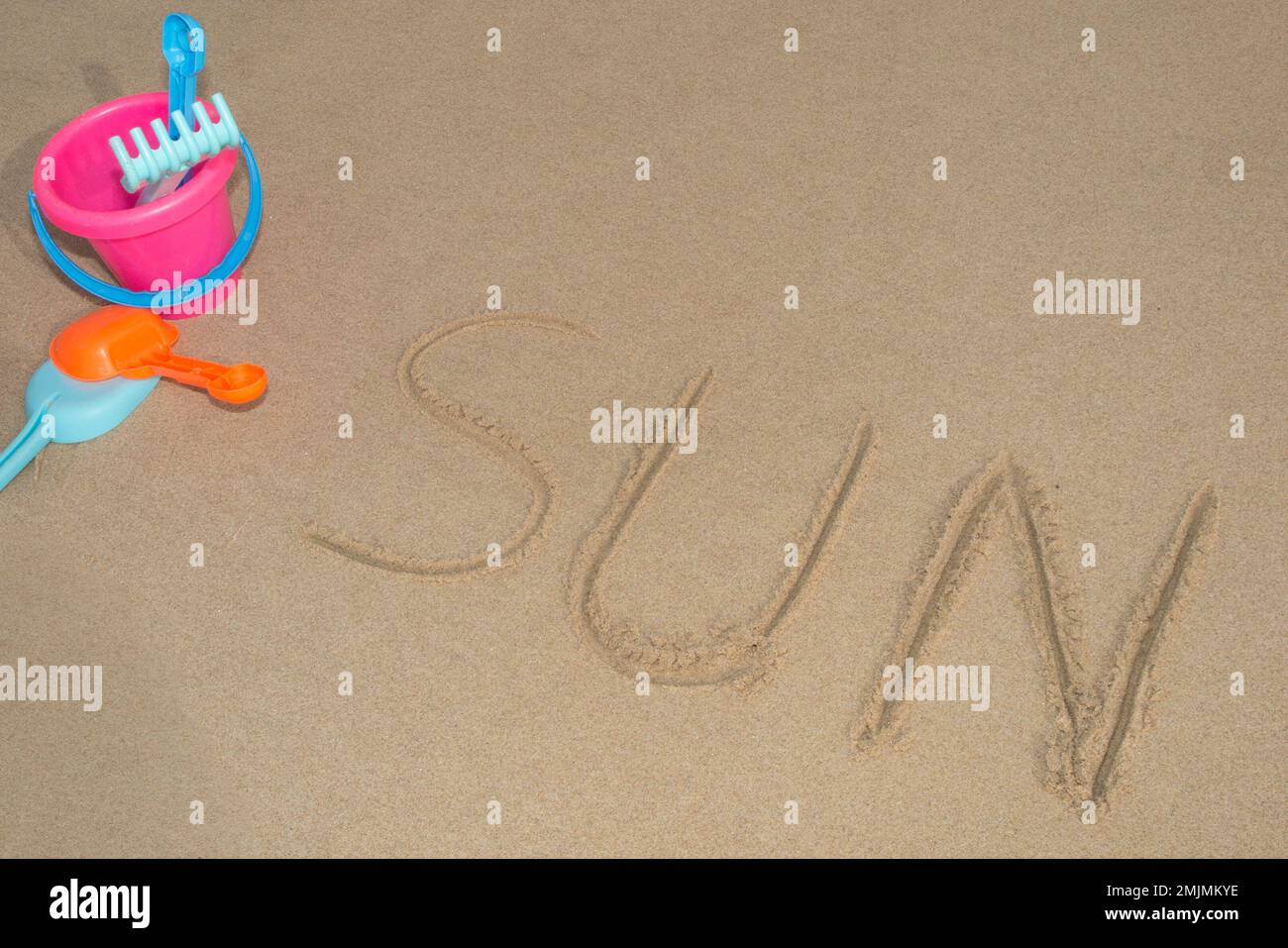 The Word Sun written in the Sand on a Beach with Drawing of the Sun ...