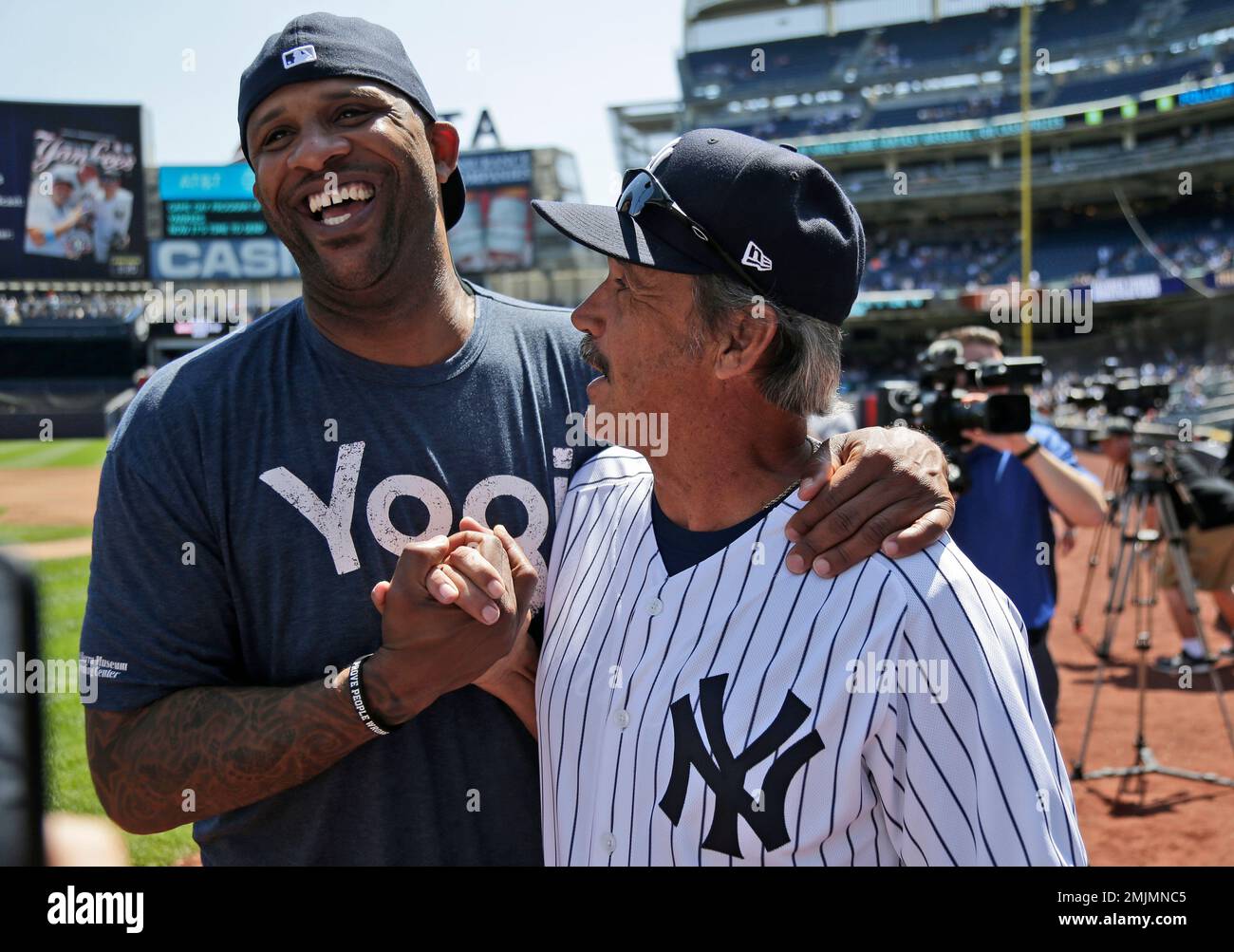 New York Yankees starting pitcher CC Sabathia, left, greets former New ...