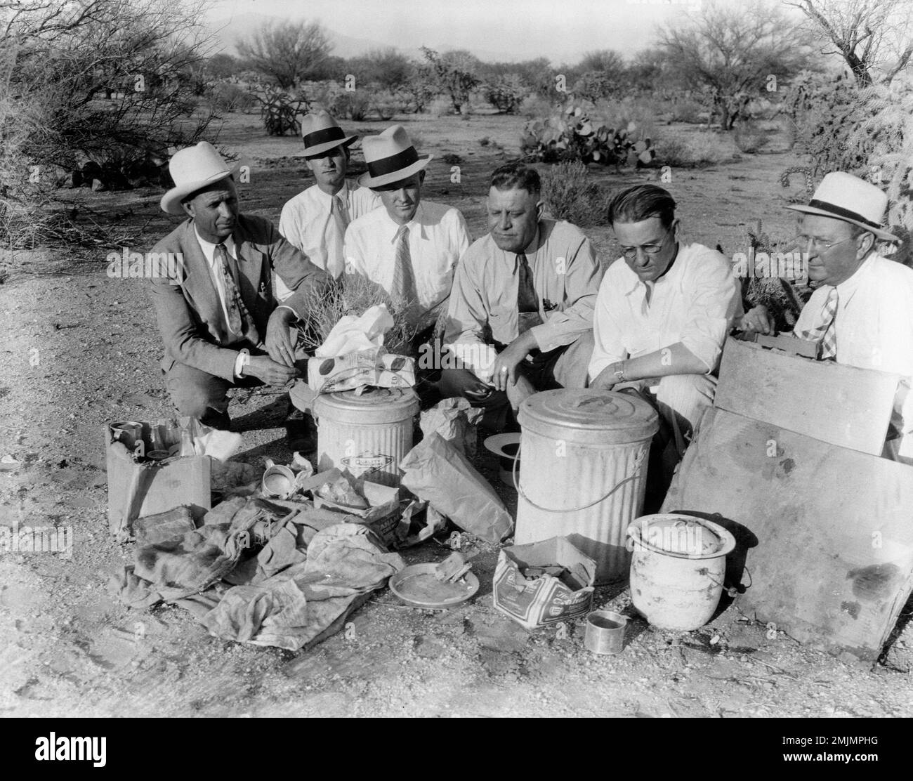 A group of unidentified Arizona officers examine the food supply and ...