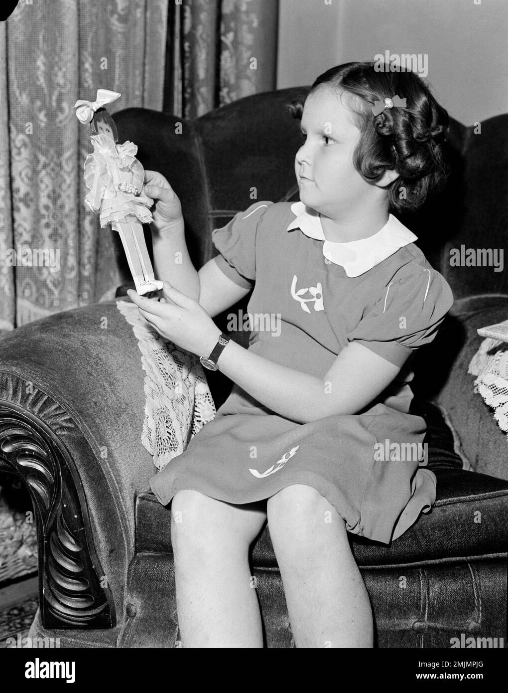 June Robles, now 9, who was kidnapped for ransom 2 years ago, admires a ...