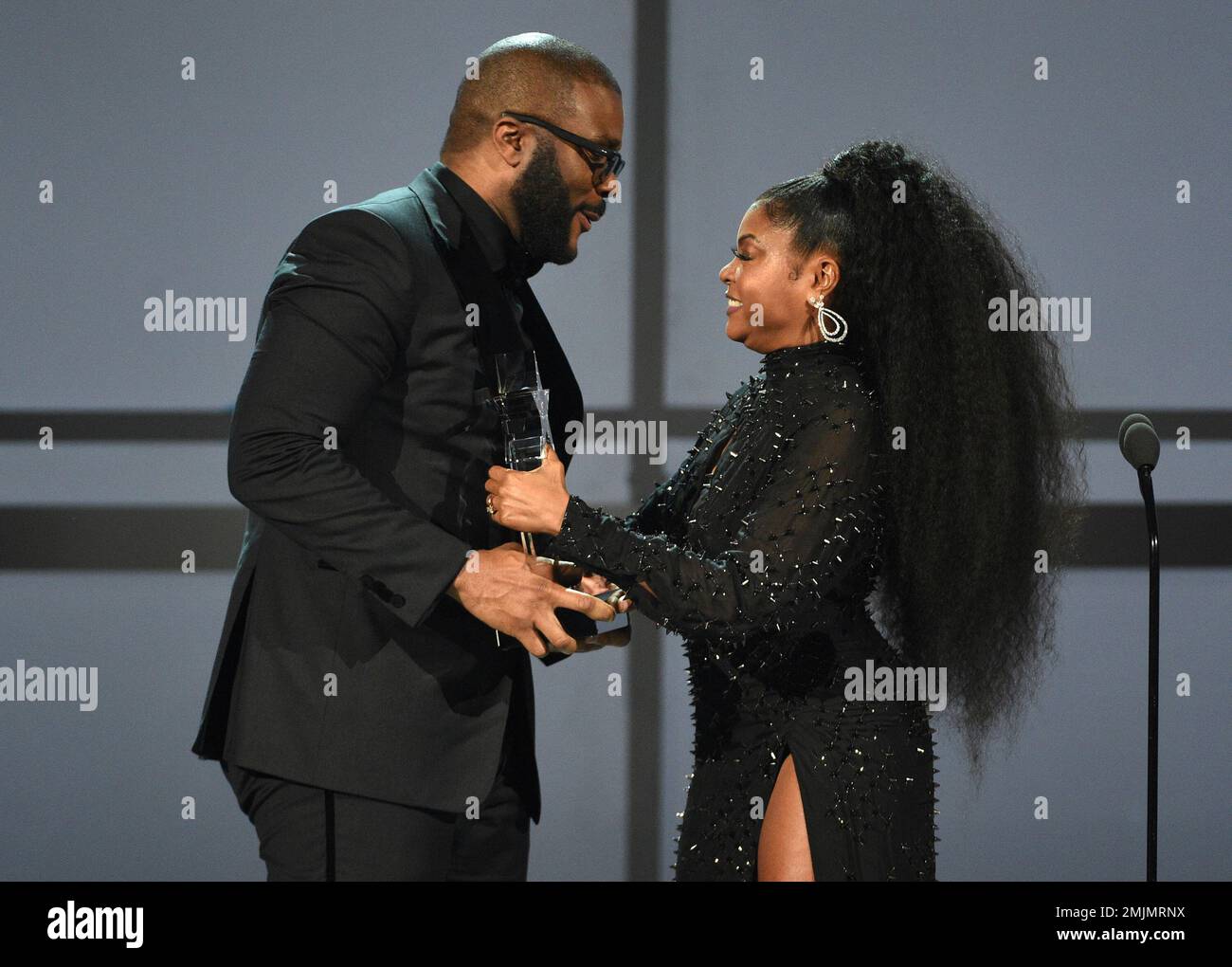 Tyler Perry, left, accepts the ultimate icon award from presenter ...