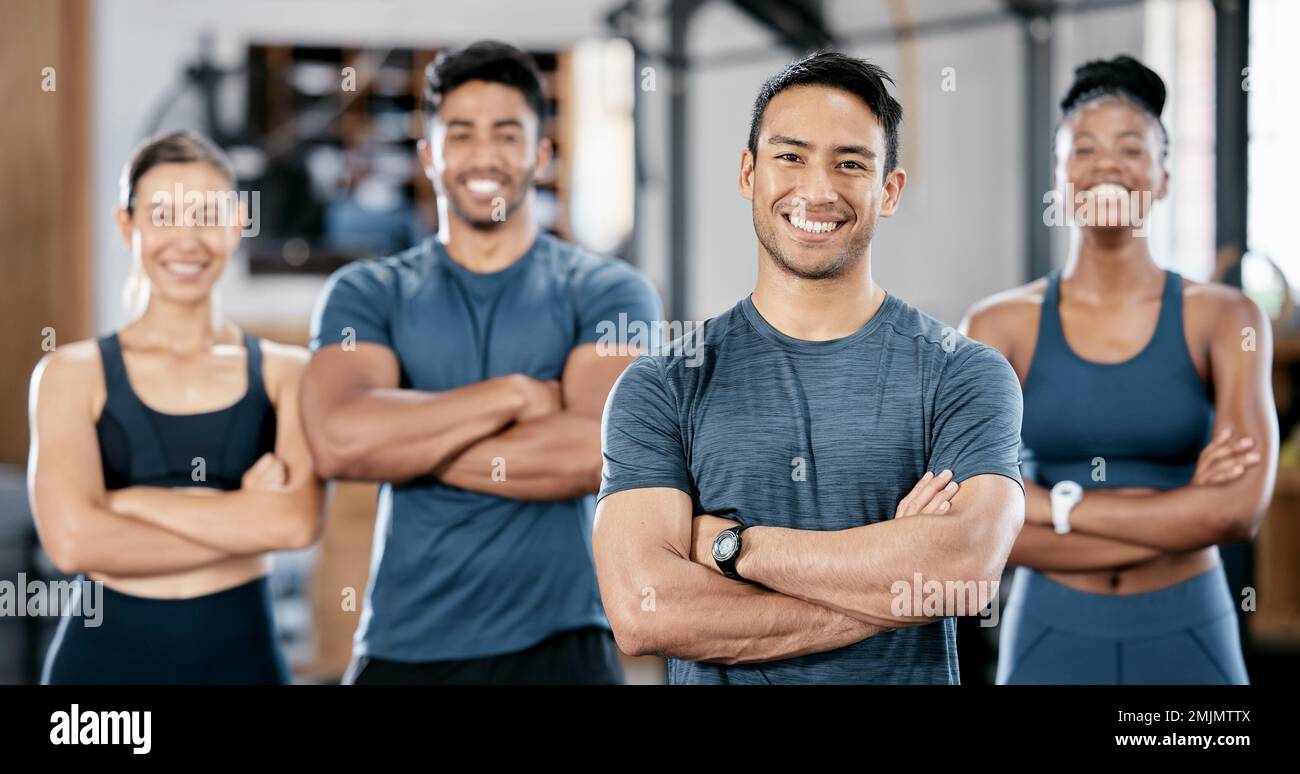 Fitness, portrait and man personal trainer with clients standing with crossed arms in the gym ...