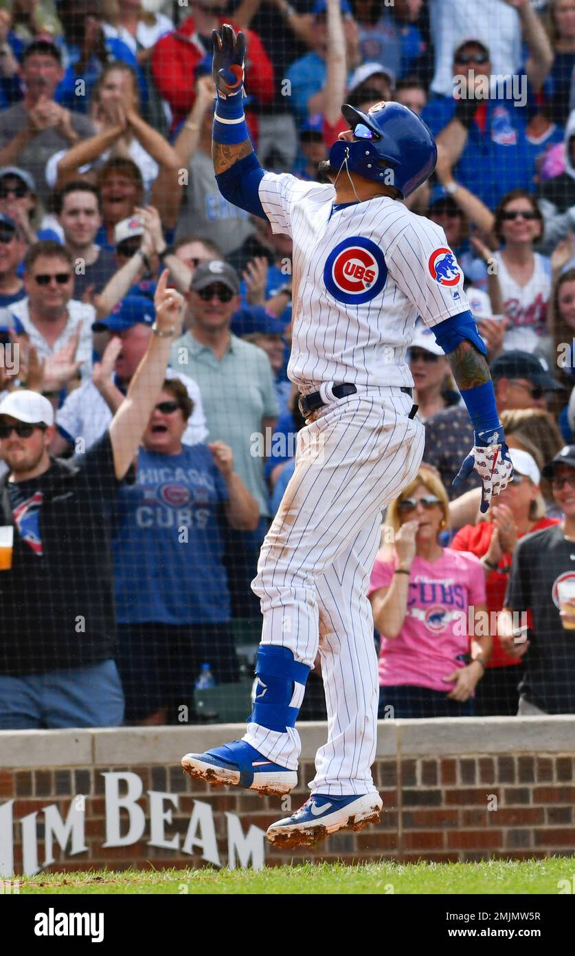 Chicago Cubs' Javier Baez (9) reacts after he hit a three run home run ...