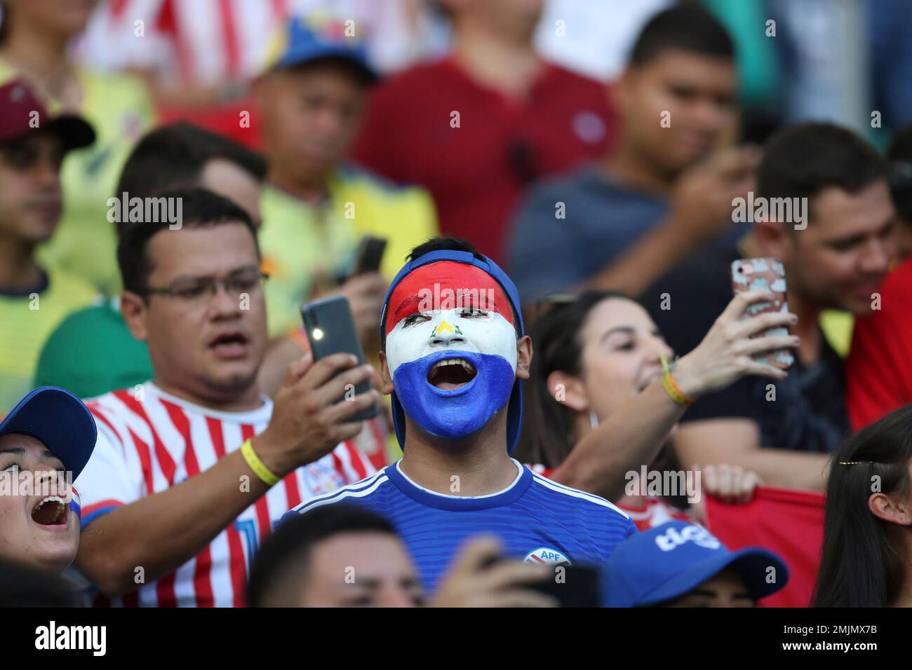A fan of Paraguay sings the national anthem prior to a Copa America ...