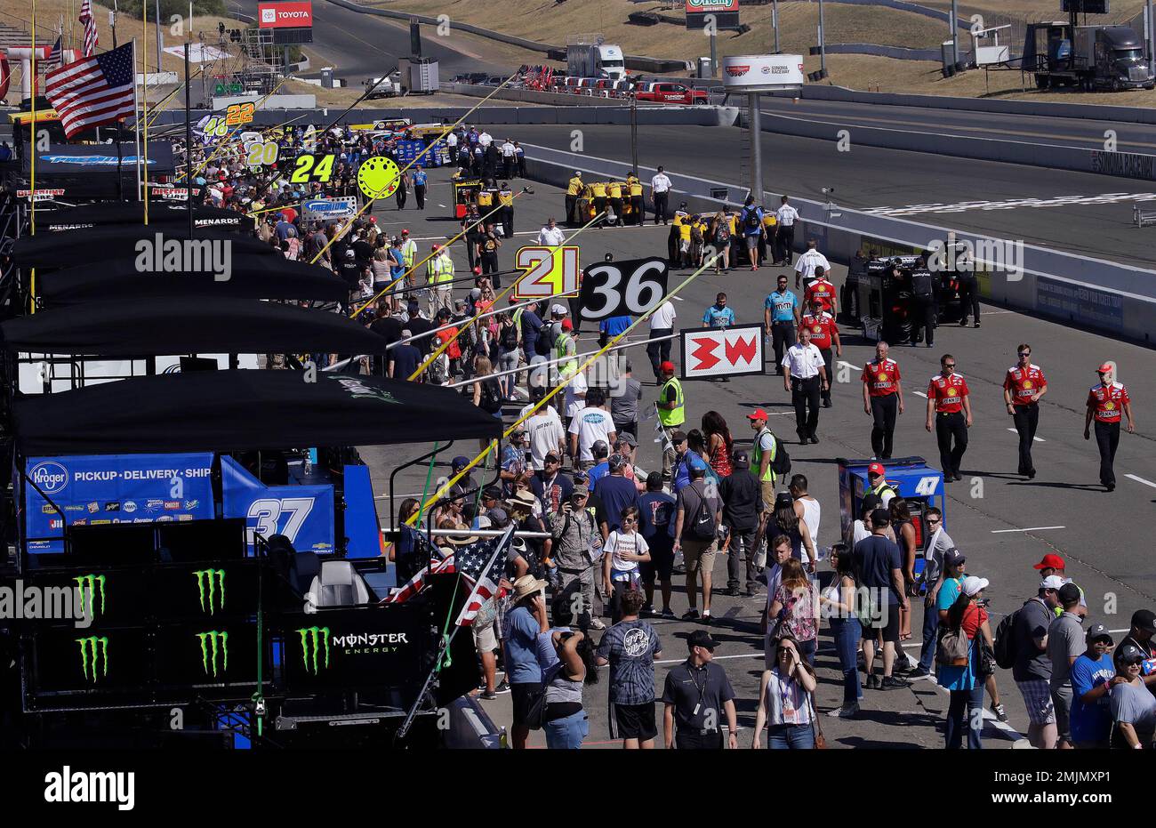 Cars are pushed into pit row in preparation for a NASCAR Sprint Cup ...