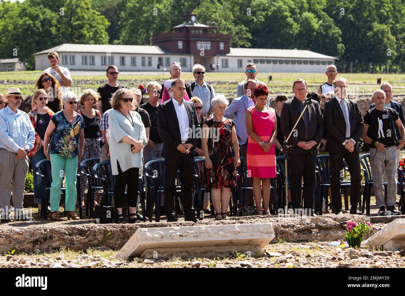 People hold a minute of silence for prisoners assigned a pink triangle ...