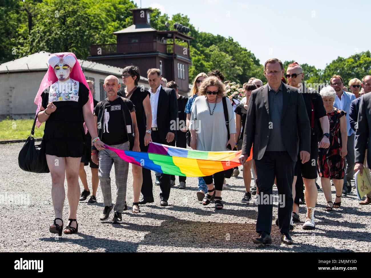 People carry a rainbow flag in remembrance for prisoners assigned a ...