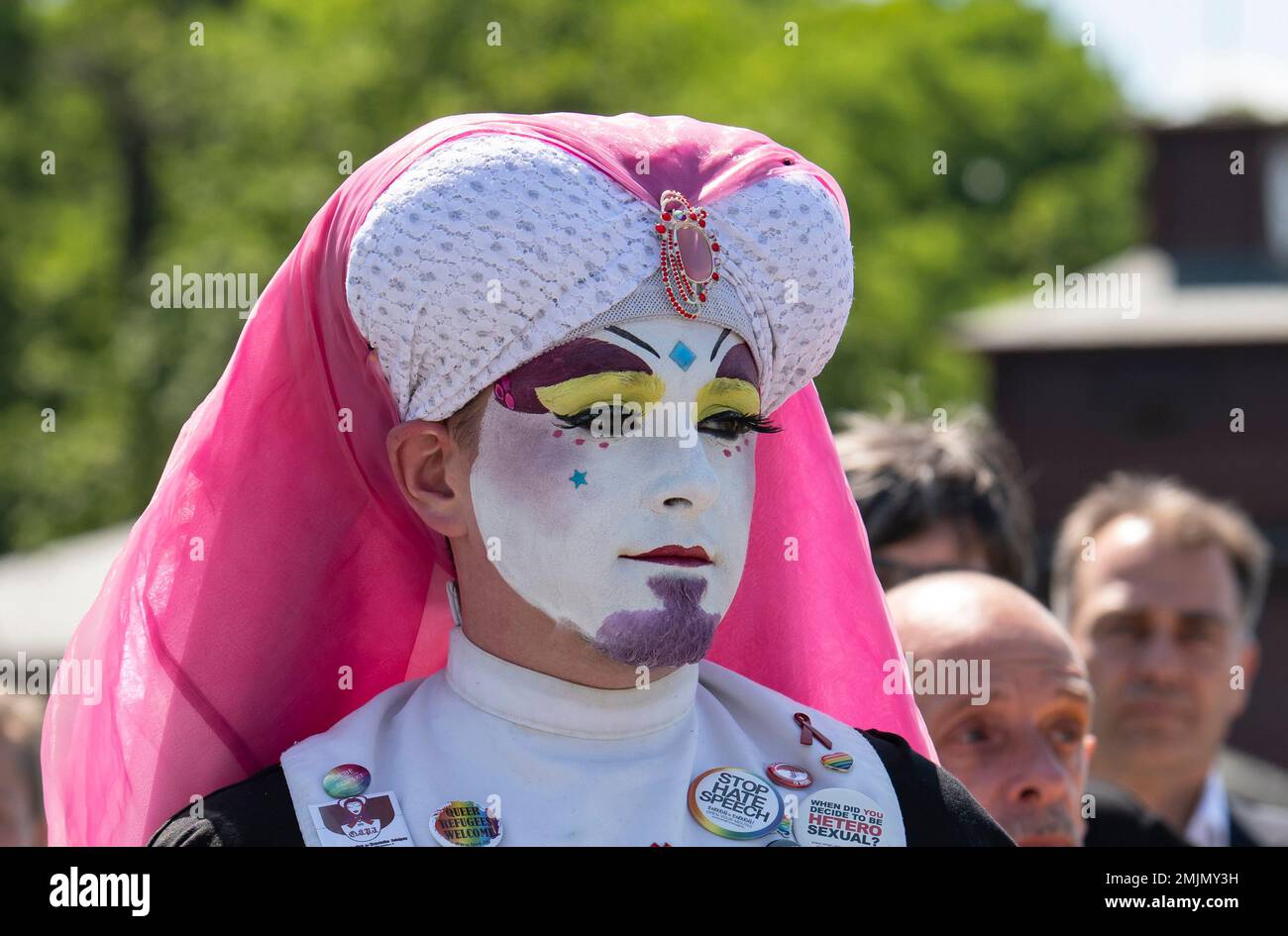 People attend a commemoration for prisoners assigned a pink triangle in ...