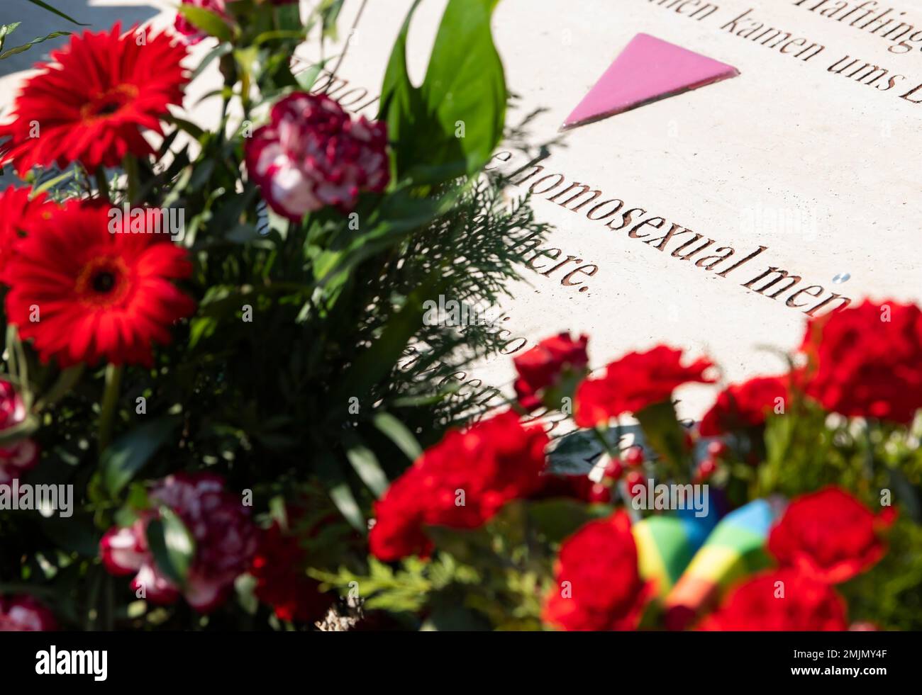 Flowers are placed at a memorial stone in remembrance for prisoners ...