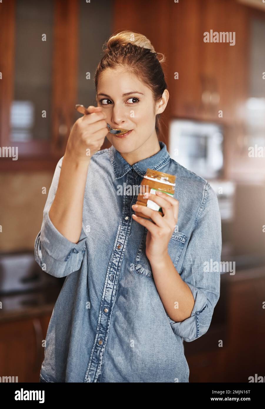 I Think Im Addicted To Peanut Butter A Young Woman Eating Peanut Butter Out Of The Jar With A