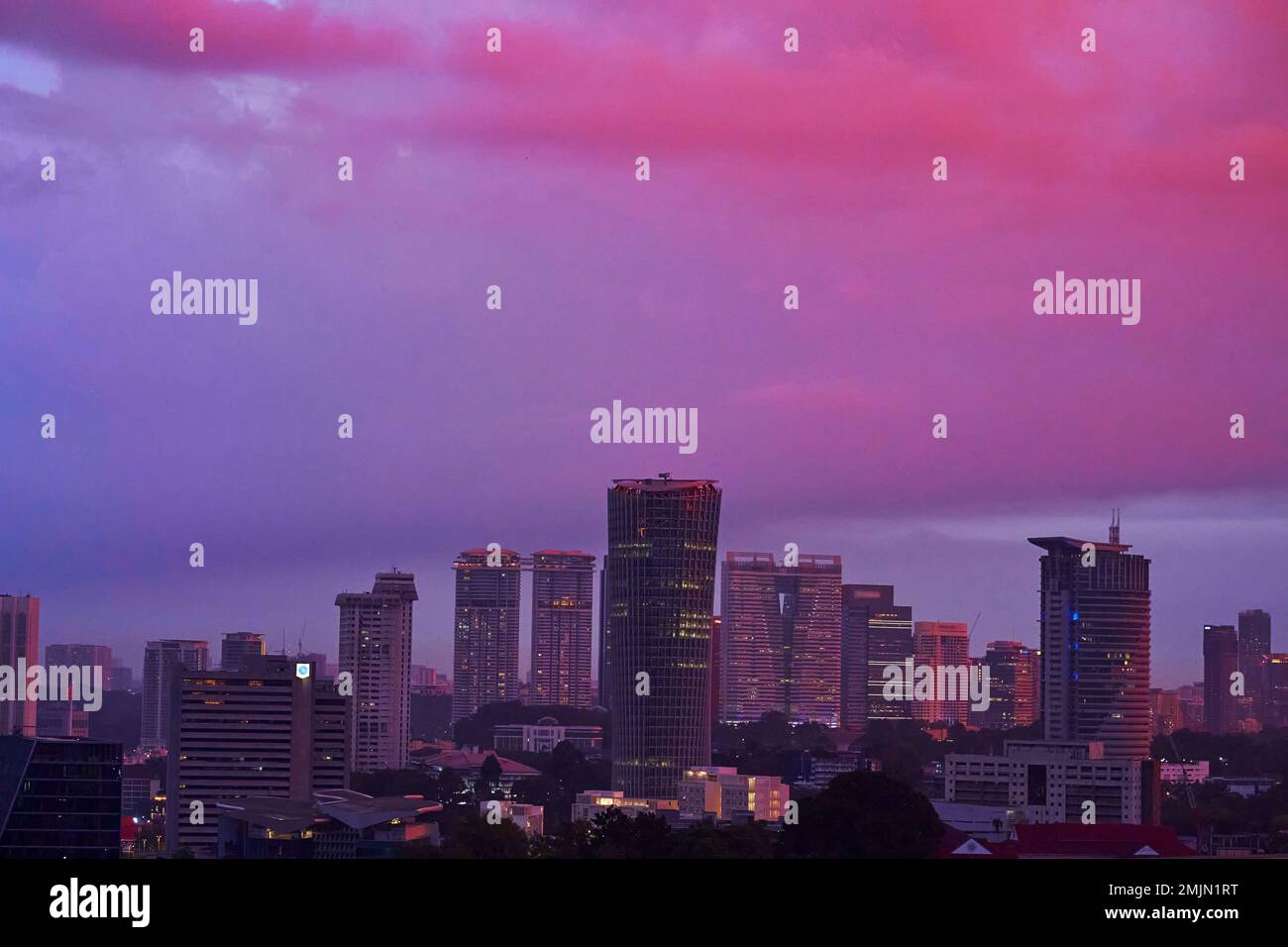 An incredible pink and purple sunset over a modern big city Stock Photo ...
