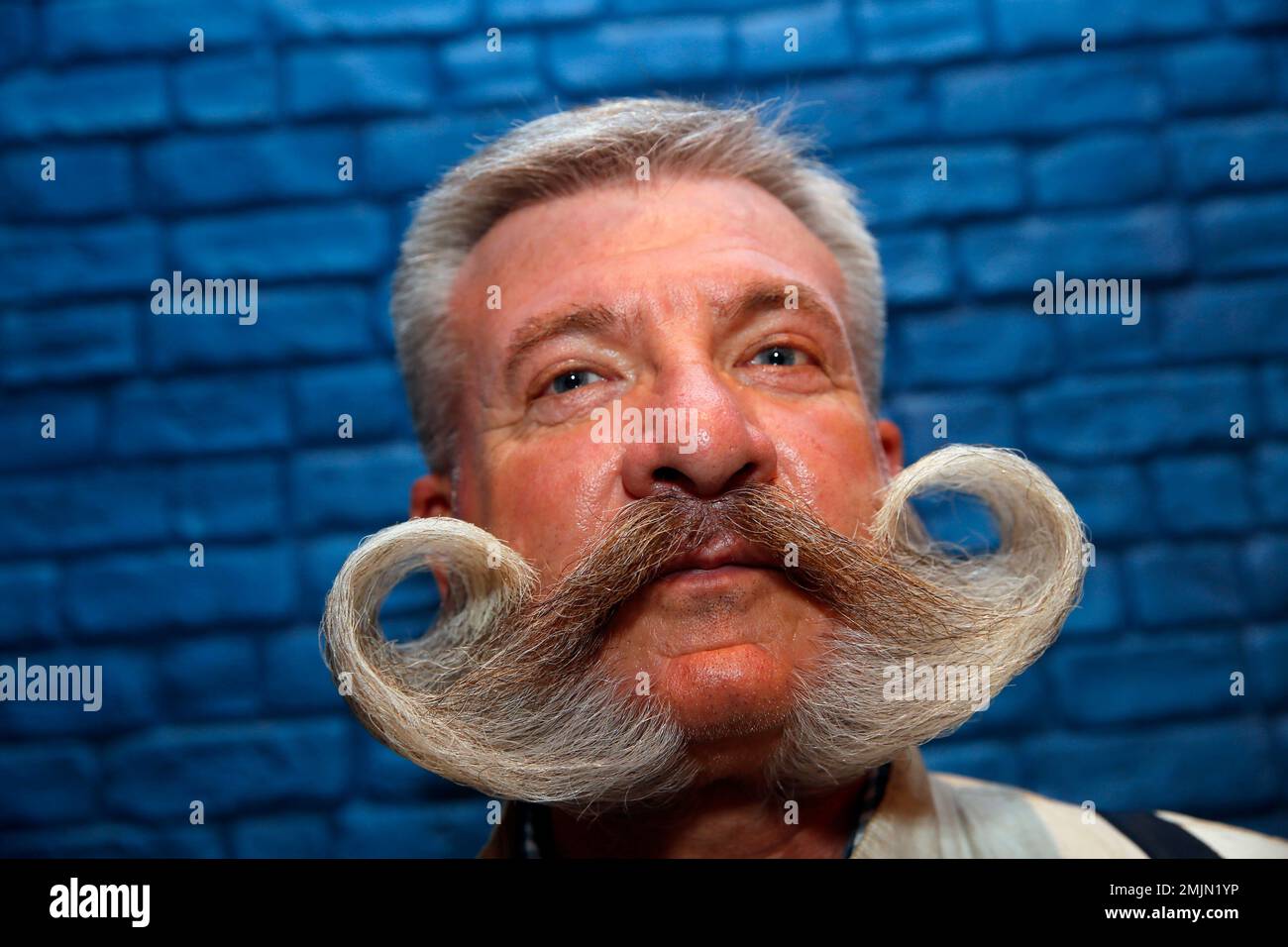 A participant poses during the France's Beard Championship to compete ...