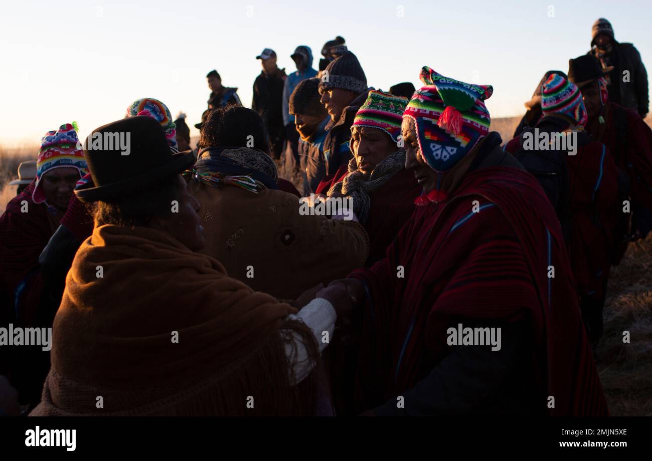 Aymara Indigenous people embrace as they receive the first rays of ...