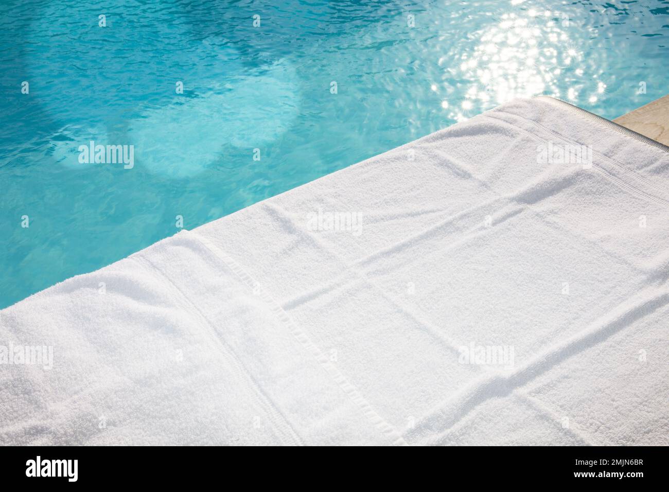towel by the pool ready for massage Stock Photo - Alamy