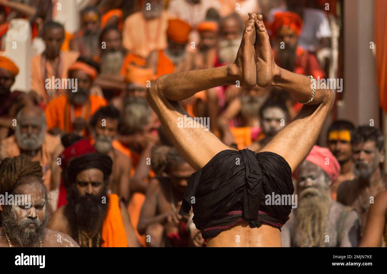 An Indian Sadhu, or Hindu holy man, performs a yoga position on ...