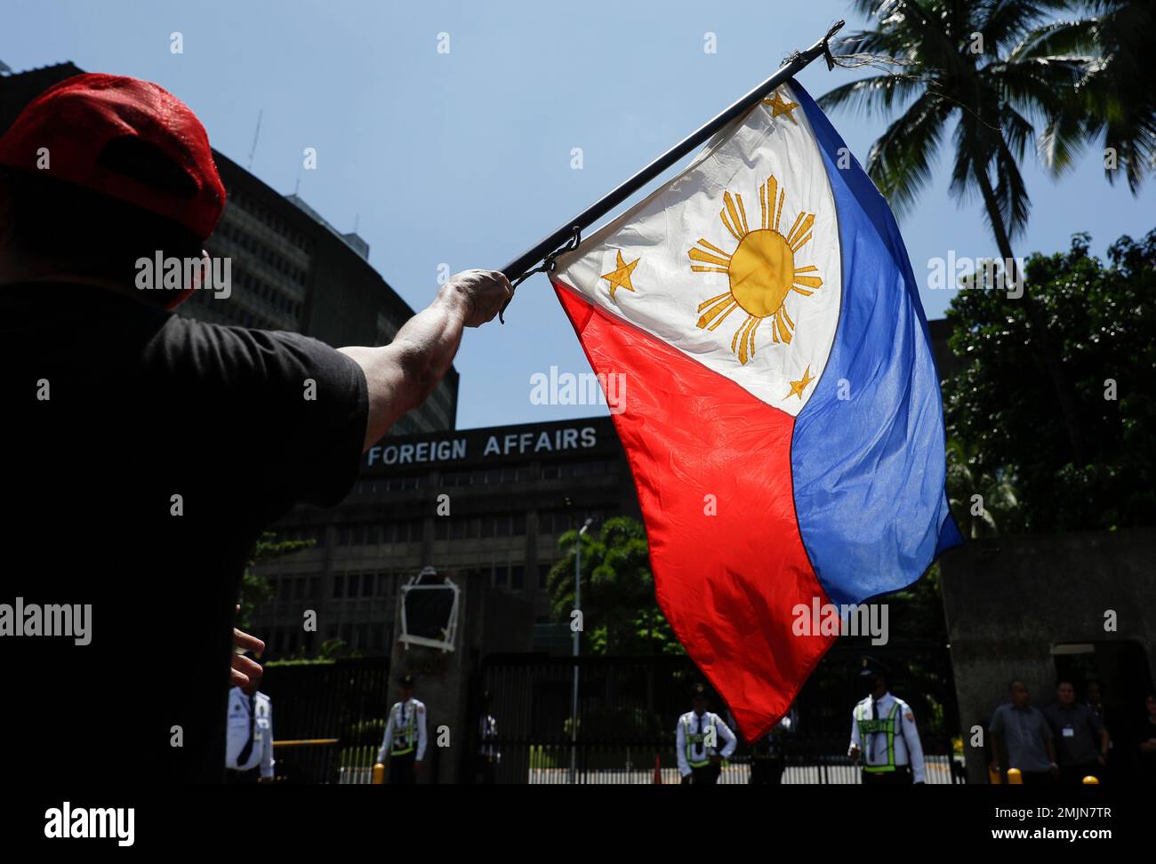 A protester waves a Philippine flag during a rally outside the ...