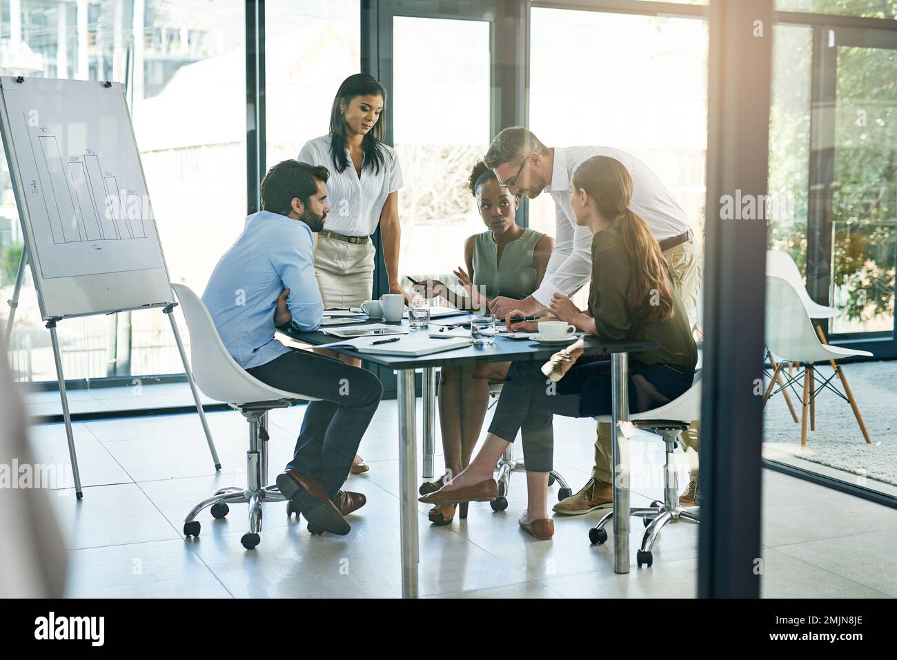 Getting their plans together. a group of colleagues working together in ...
