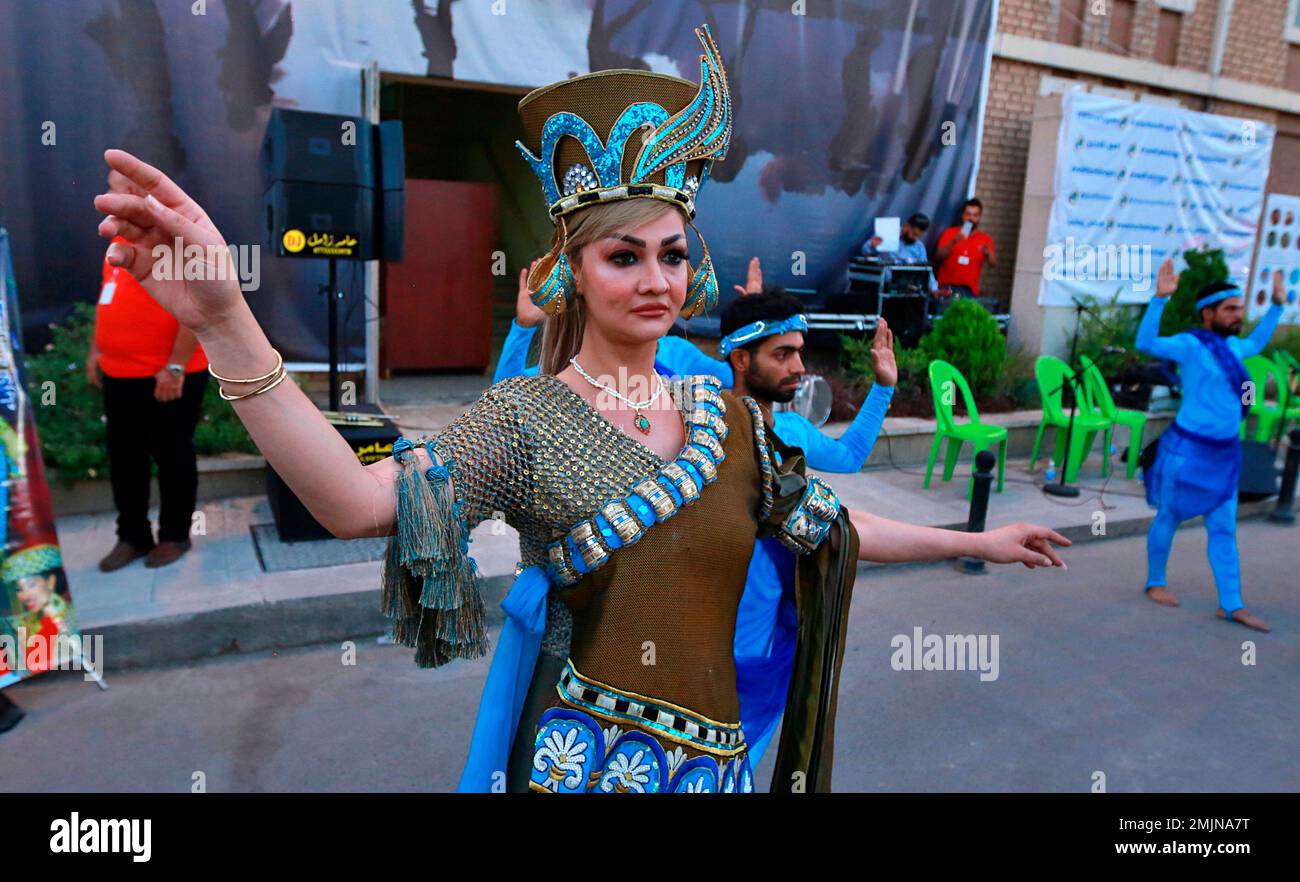 Dancers wearing traditional Iraqi folk costume perform during World ...