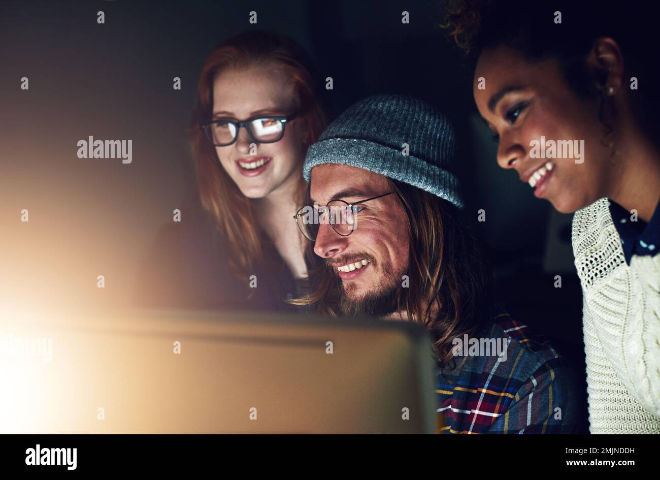 We always have fun while working late. a business team looking at a ...