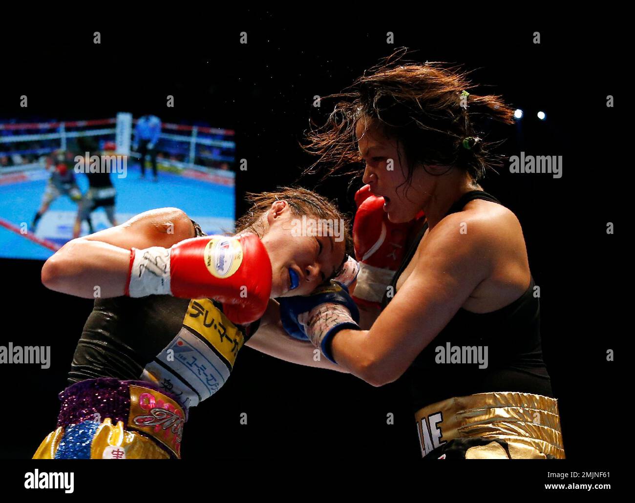 Japan's Miyo Yoshida, left, and Casey Morton of the U.S. exchange punches in the ninth round of ...