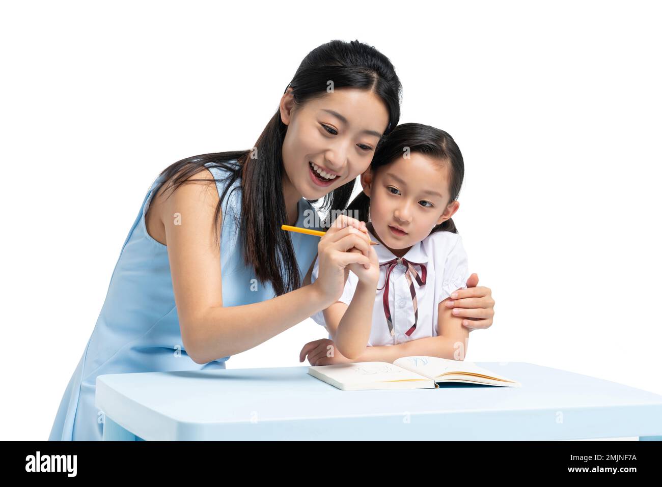 A young female teacher counseling students learning Stock Photo - Alamy