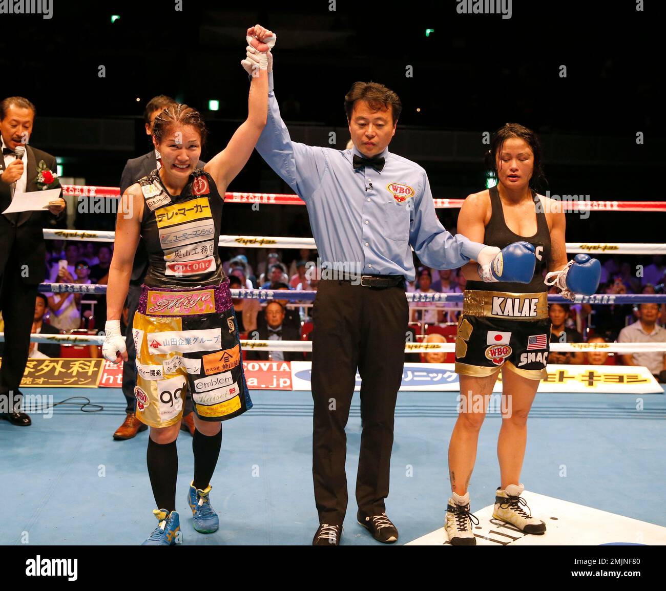 Japan's Miyo Yoshida, left, is declared the winner after defeating ...