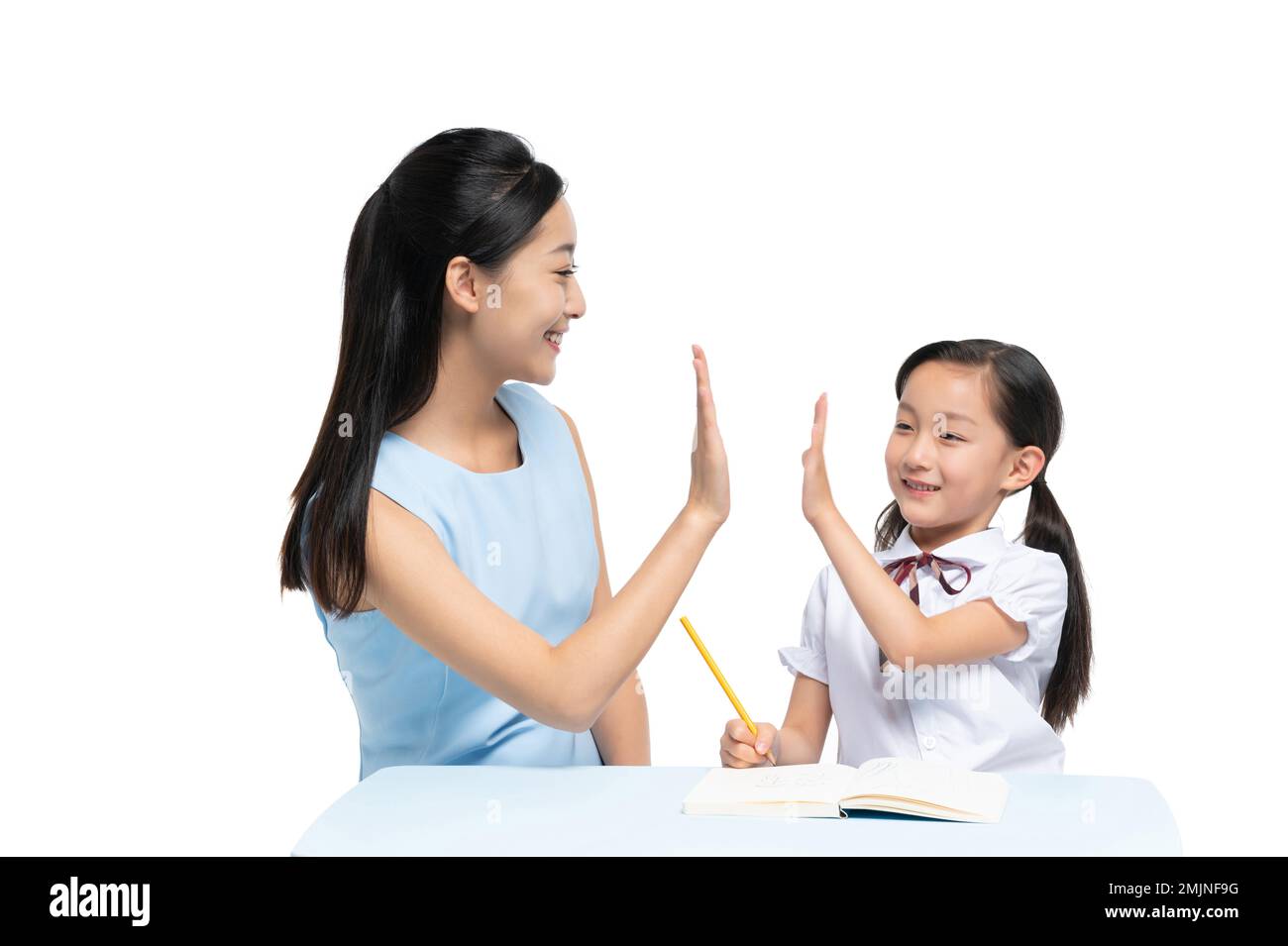 A young female teacher counseling students learning Stock Photo - Alamy