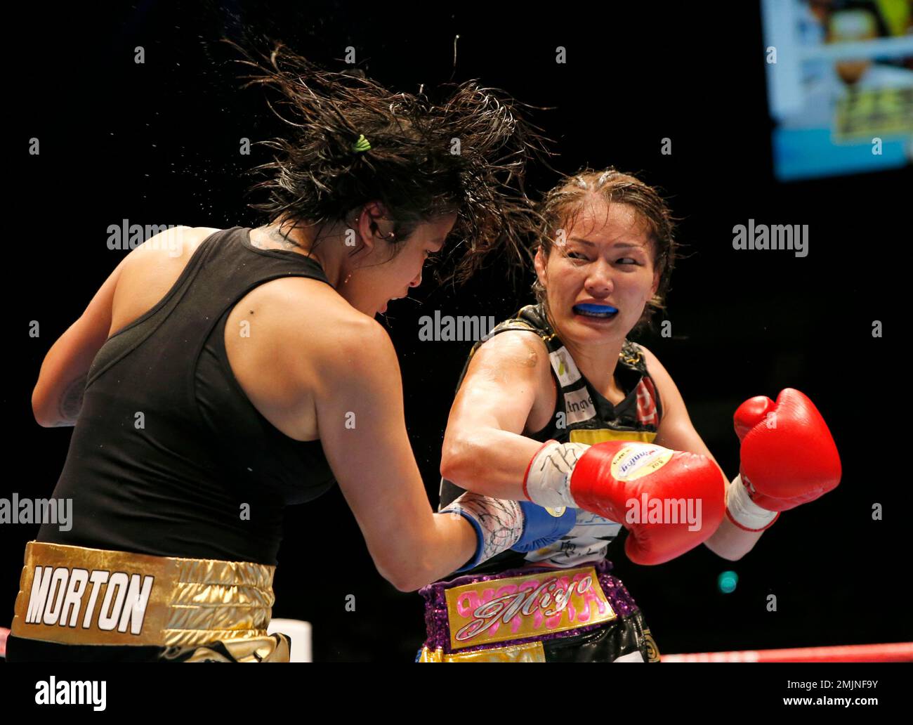 Japan's Miyo Yoshida, right, sends a right to Casey Morton of the U.S ...