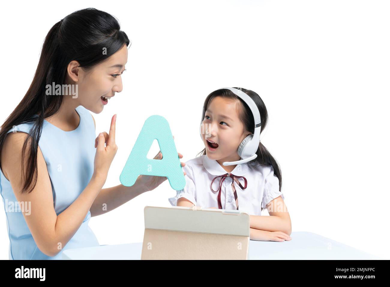 A young female teacher counseling students learning Stock Photo - Alamy