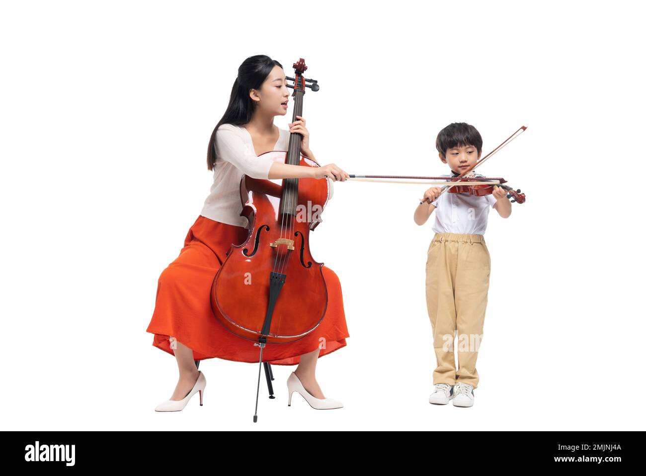 The female teacher guide the boy playing Musical Instruments Stock ...