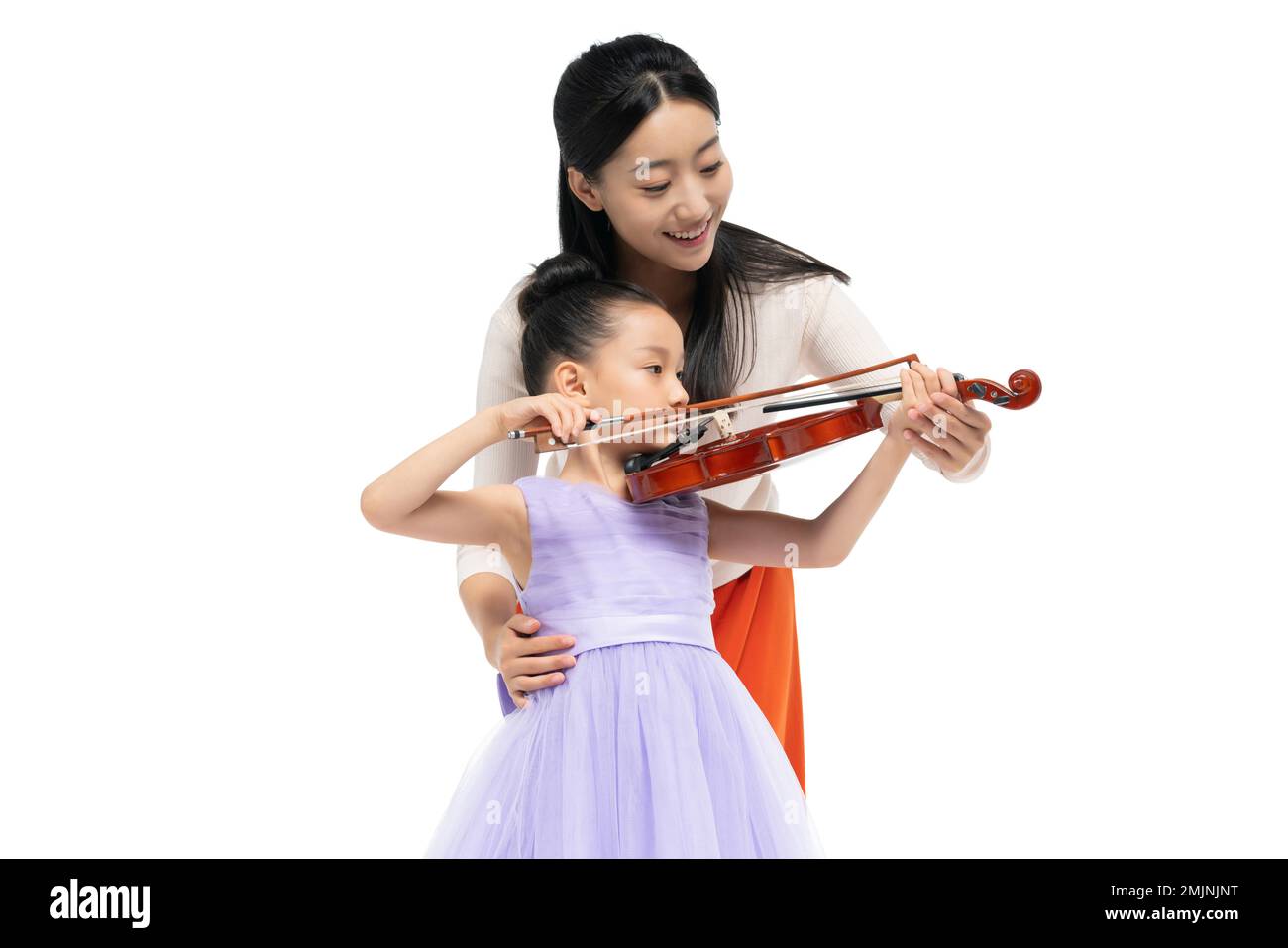 The female teacher guide girl playing Musical Instruments Stock Photo ...